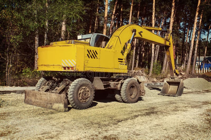 The Modern Excavator Performs Excavation Work on the Construction Site ...