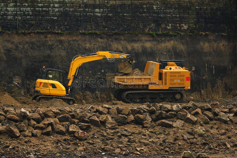 The Modern Excavator Performs Excavation Work on the Construction Site ...