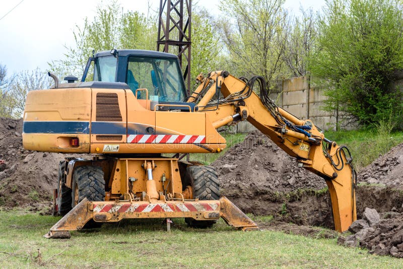 The Modern Excavator Performs Excavation Work on the Construction Site ...