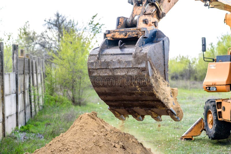 The Modern Excavator Performs Excavation Work on the Construction Site ...