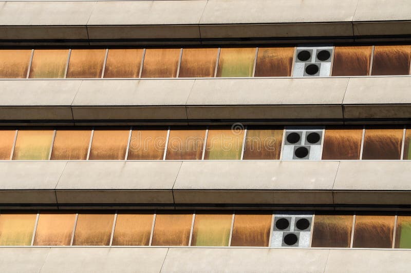 Modern Facade with Symmetrical Windows and Vents Reflecting Golden ...