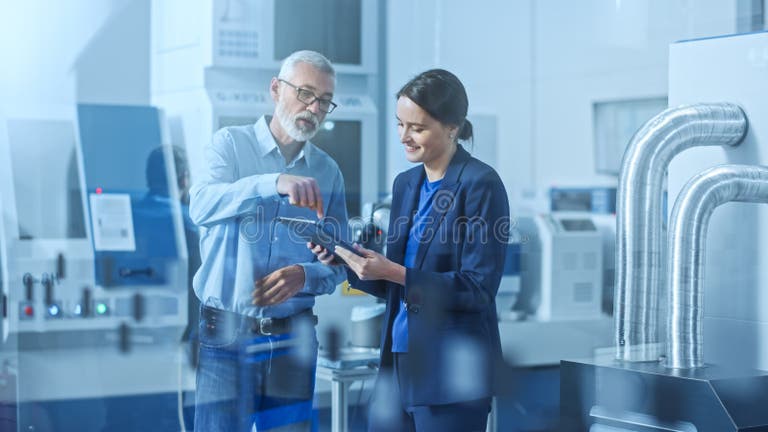 Modern Factory: Female Engineer, Male Project Manager Standing in High Tech Development Facility ...