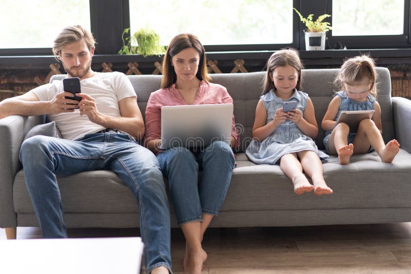 Modern Family Values. Father, Mother and Daughters Using Electronic ...