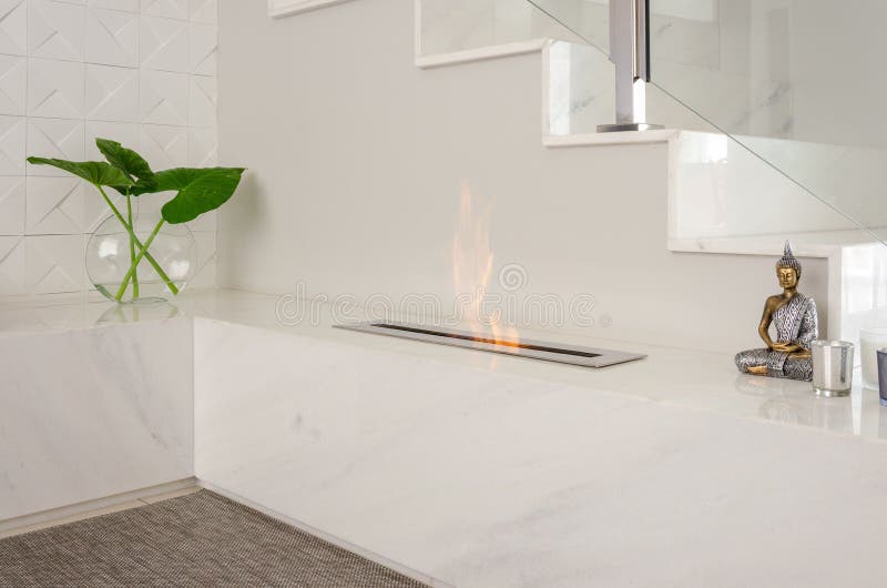 Modern Fireplace Design on a Marble White Table with a Plant Near ...