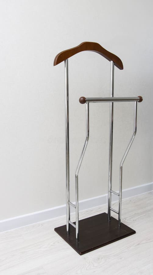 Modern Floor Standing Suit Rack Against a White Wall Stock Photo ...