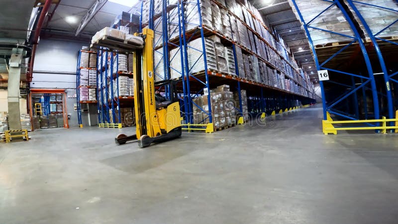 Modern Forklift in a Large Warehouse. Forklift with Cargo in the ...