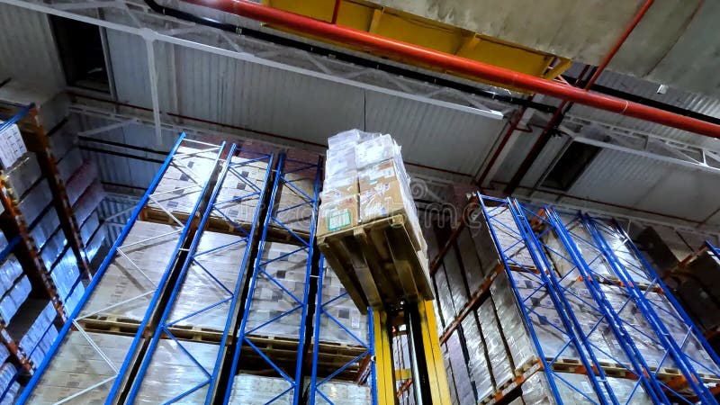 Modern Forklift in a Large Warehouse. Forklift with Cargo in the ...
