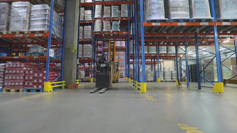 Large Modern Warehouse. a Modern Forklift Rides through a Warehouse ...