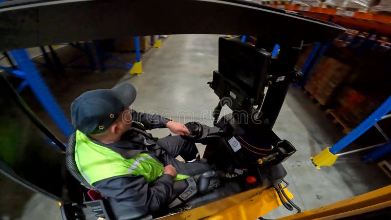 Modern Forklift Works in a Warehouse. the Work of a Forklift in a ...