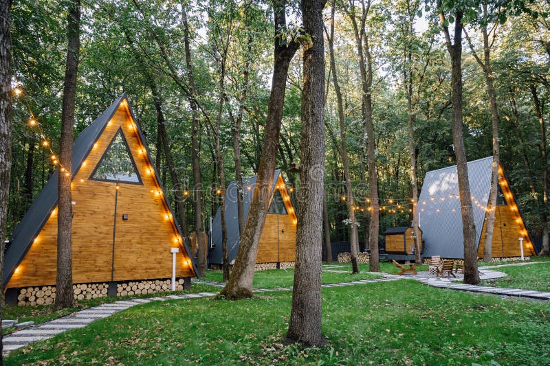 Modern a-frame Cabins with Glowing String Lights in Forest Environment ...