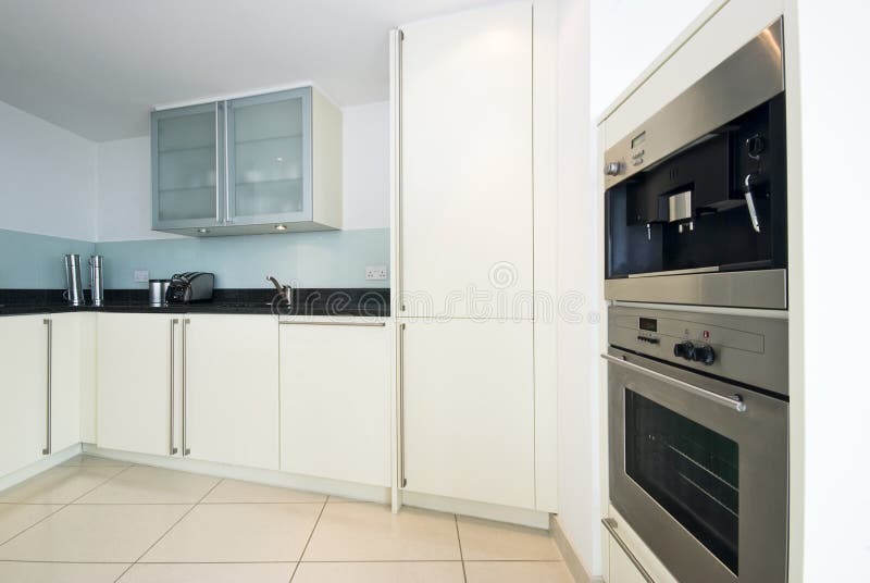 Fully Fitted Contemporary Kitchen in White Stock Image - Image of food ...