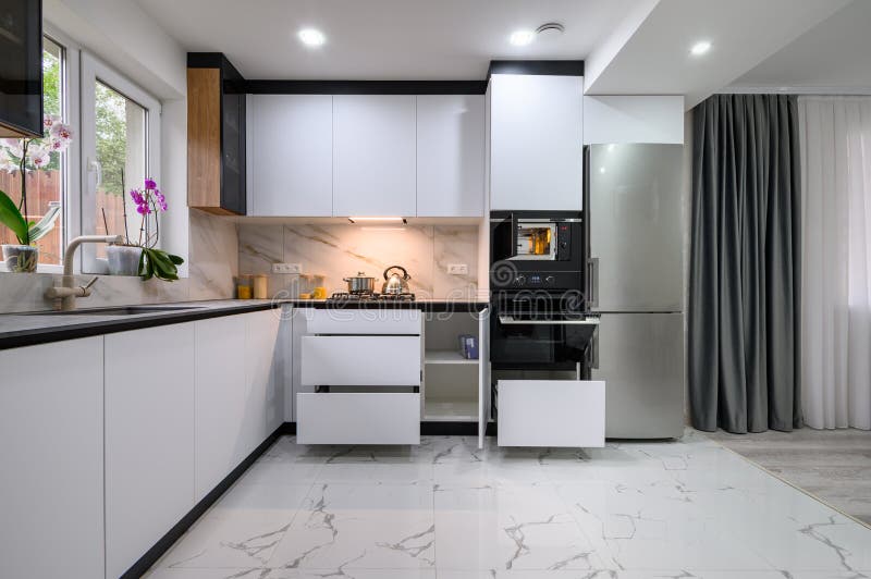 A Modern and Functional Kitchen with a White Design, a Marble Floor, an ...