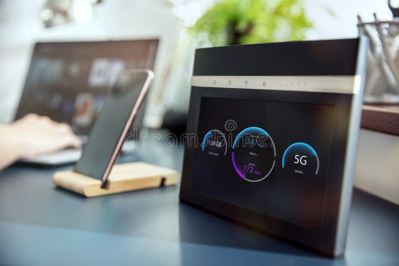 Modern 5G Wi-fi Router with Display on the Desk and Devices on the ...