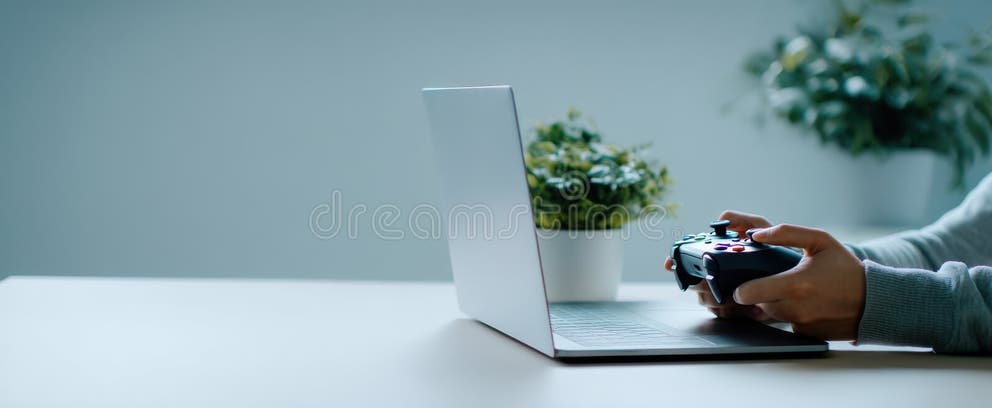 The Modern Gaming Experience with a Laptop and Controller on a Table ...
