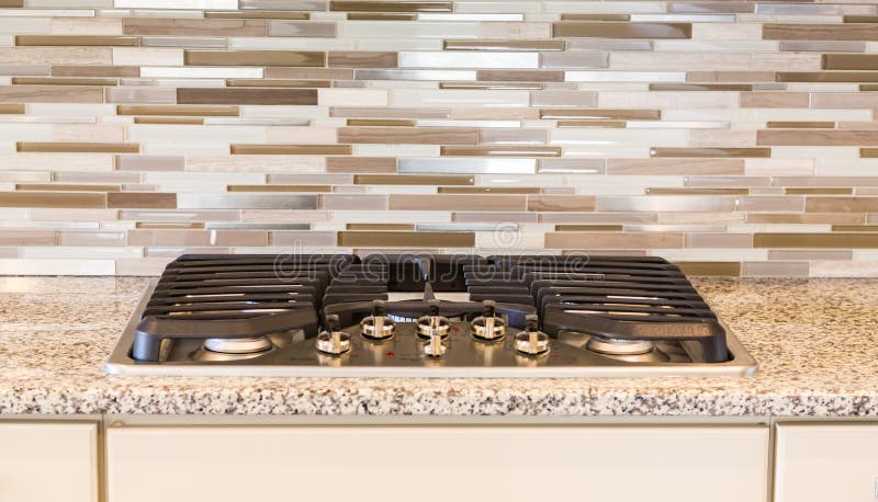 Modern Gas Cooktop with Granite and Tile Stock Image - Image of burner ...