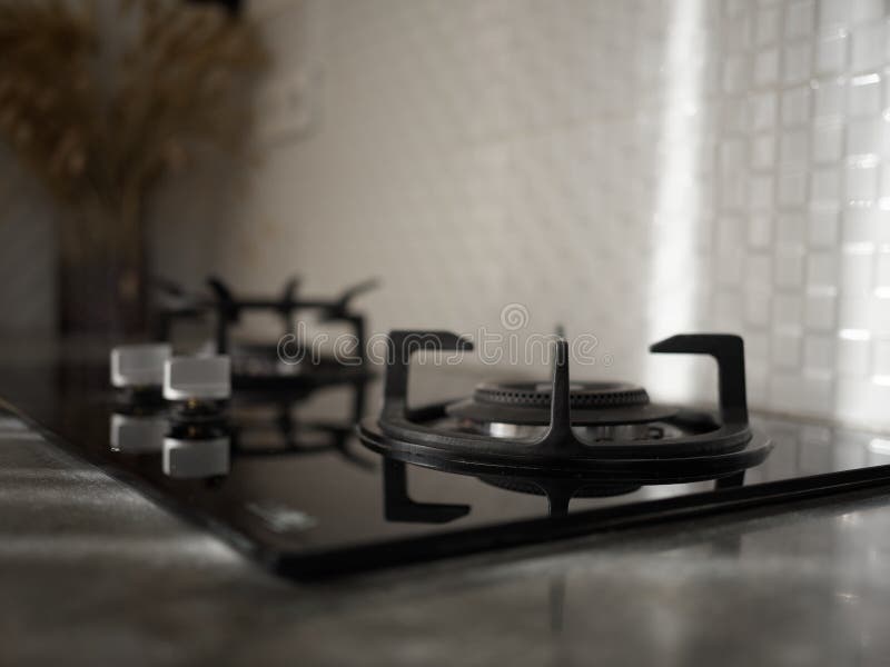 Modern Gas Stove Built into a Black Table in the Kitchen. Stock Image ...