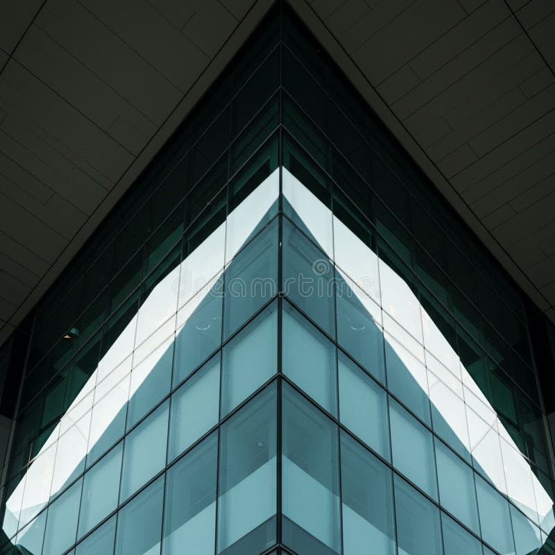Modern Glass Building Corner with Reflective Windows Forming a Sharp ...