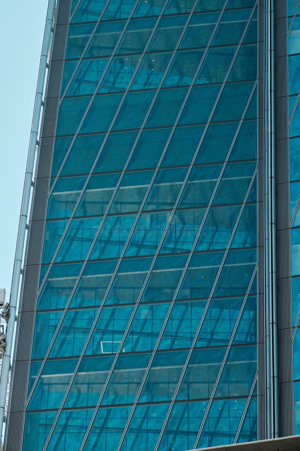 A Modern Glass Building Facade that Features Unique Geometric Lines and ...