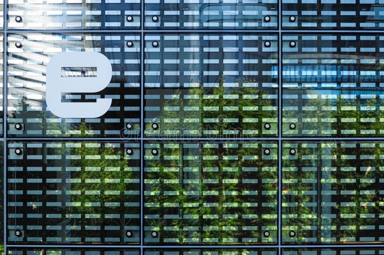 Modern Glass Building Facade Reflecting Green Trees, Featuring a Unique ...