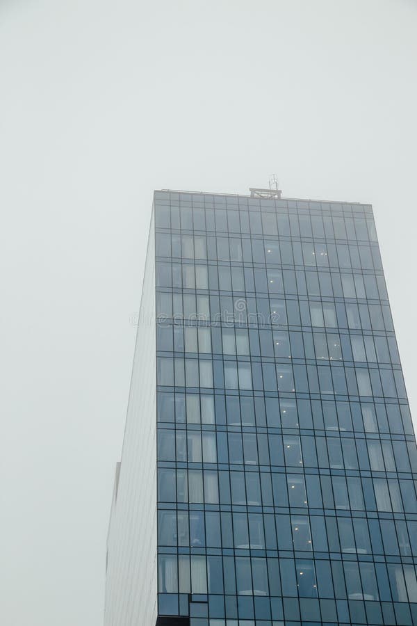 Modern Glass Building on Foggy Sky Background, Bottom View Stock Photo ...