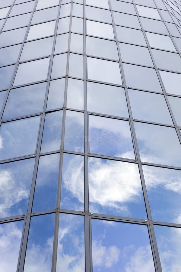 Modern Glass Building with Reflections of Blue Sky and Clouds Stock ...