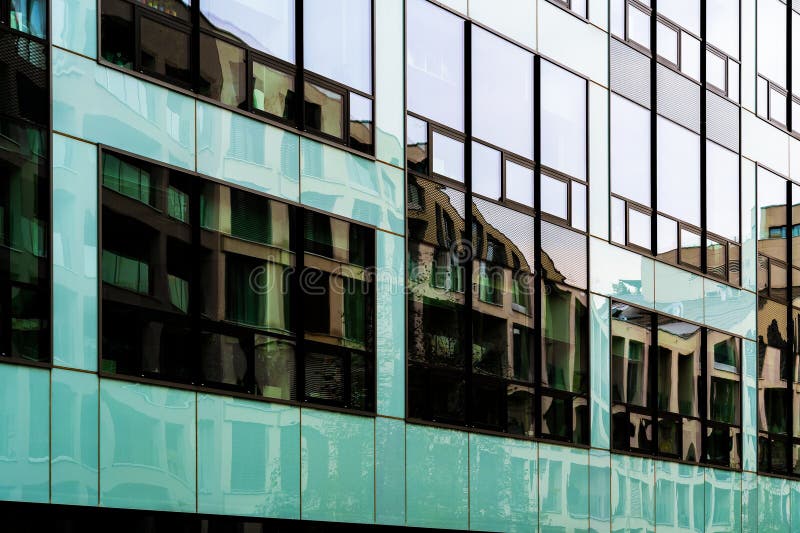 Modern Glass Facade with Reflective Panels and Angular Architectural ...