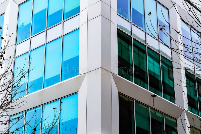 Modern Glass Facade with Reflective Panels and Angular Architectural ...