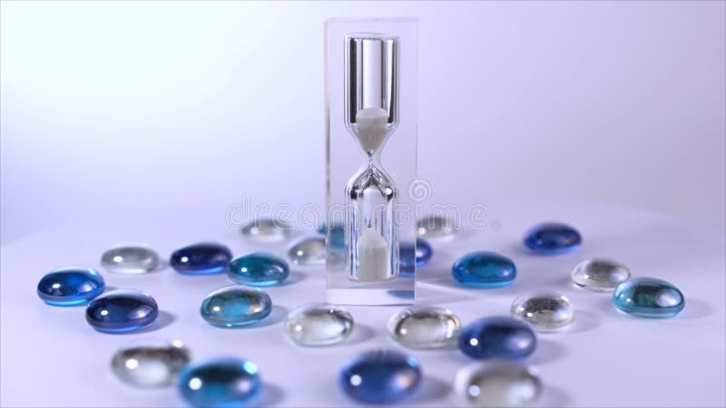 Modern Glass Hourglasses Rotate Against a White Background Stock Photo ...
