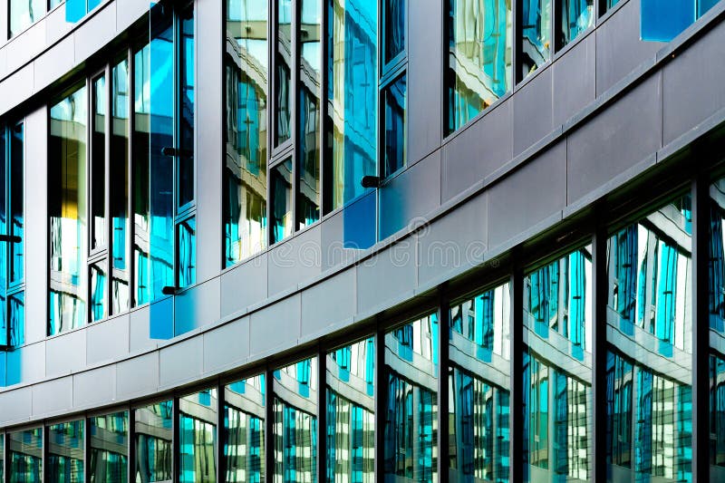 Modern Glass Office Building with Blue-Tinted Windows and Sleek ...