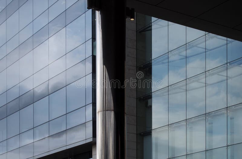 Modern Glass Office Buildings Behind a Steel Column with Blue Sky ...