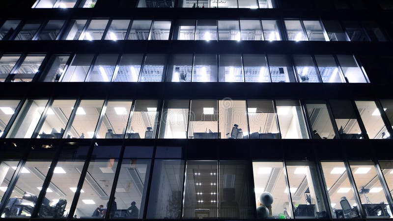Office Building in the Evening with Lightened Workspaces. Stock Image ...