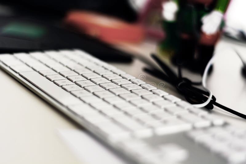 A Modern Gray Computer Keyboard with White Keys on an Office Table ...