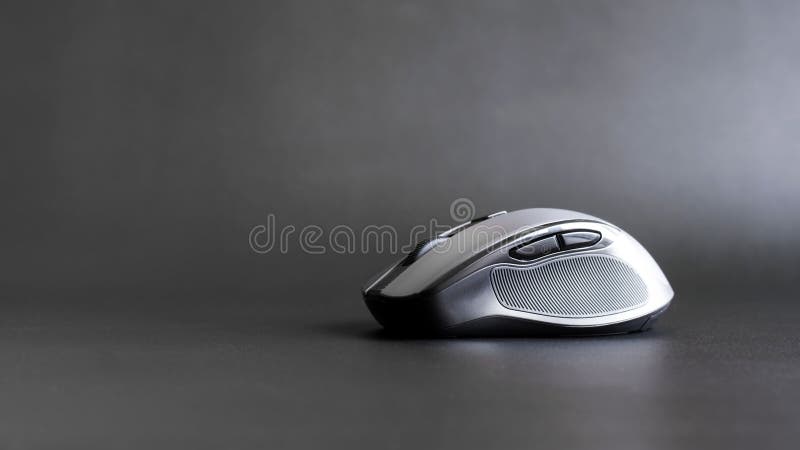 Modern Gray Wireless Computer Mouse on a Gray Textured Background. Side ...