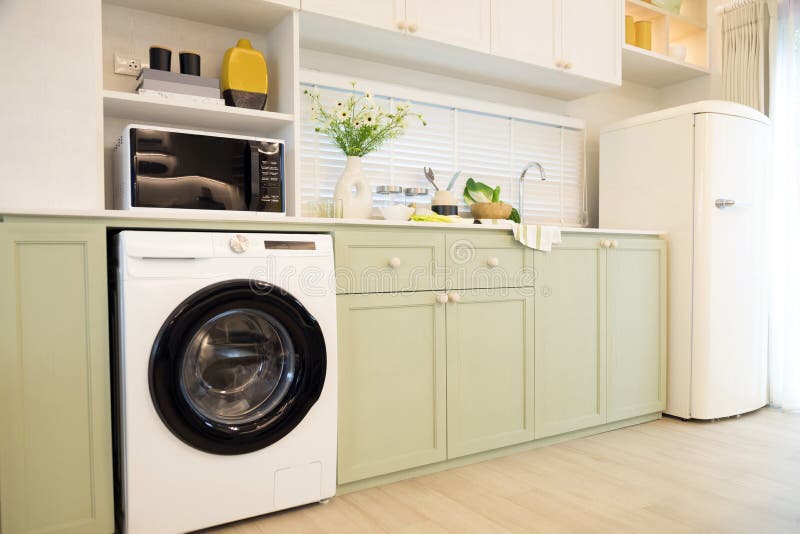 Modern Green Kitchen Interior with Washing Machine and Microwave. Stock ...