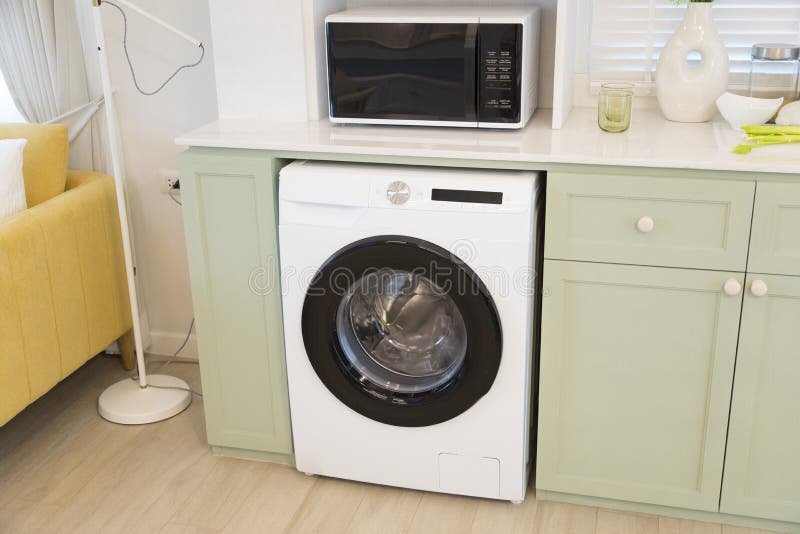 Modern Green Kitchen Interior with Washing Machine and Microwave. Stock ...
