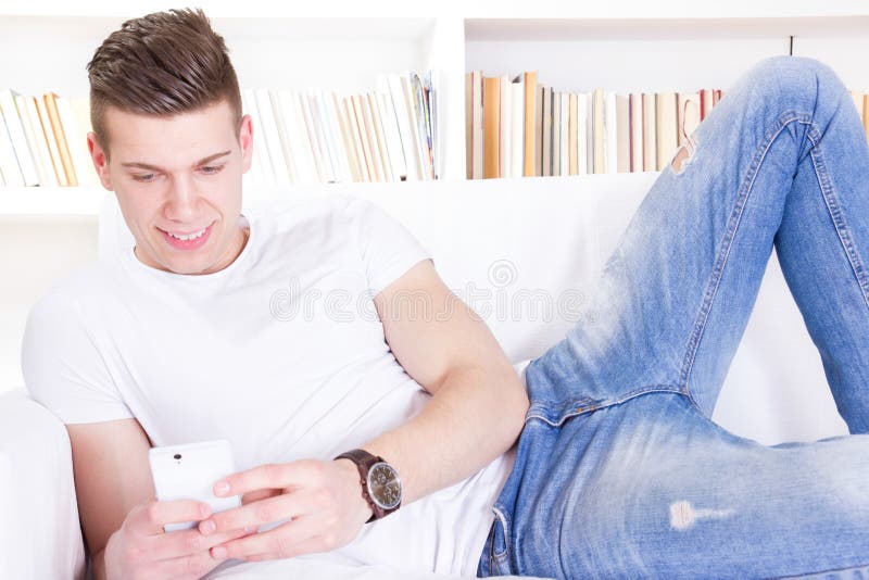 Modern Guy Using Smart Phone Relaxing on Sofa at Home Stock Image ...