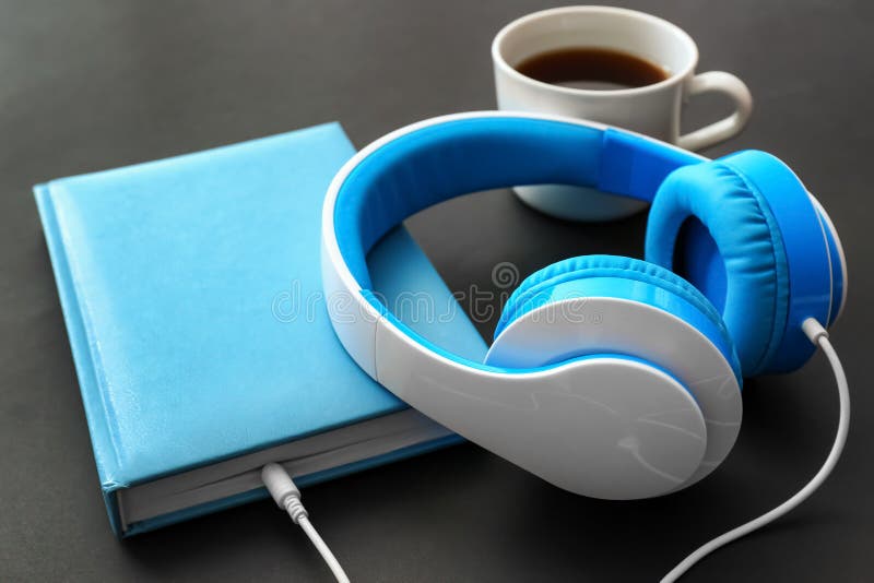 Modern Headphones and Book on Table. Concept of Audiobook Stock Photo ...