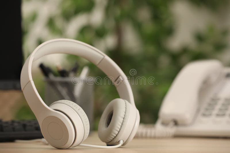 Modern Headphones, Desktop Telephone and Computer on Table Indoors ...