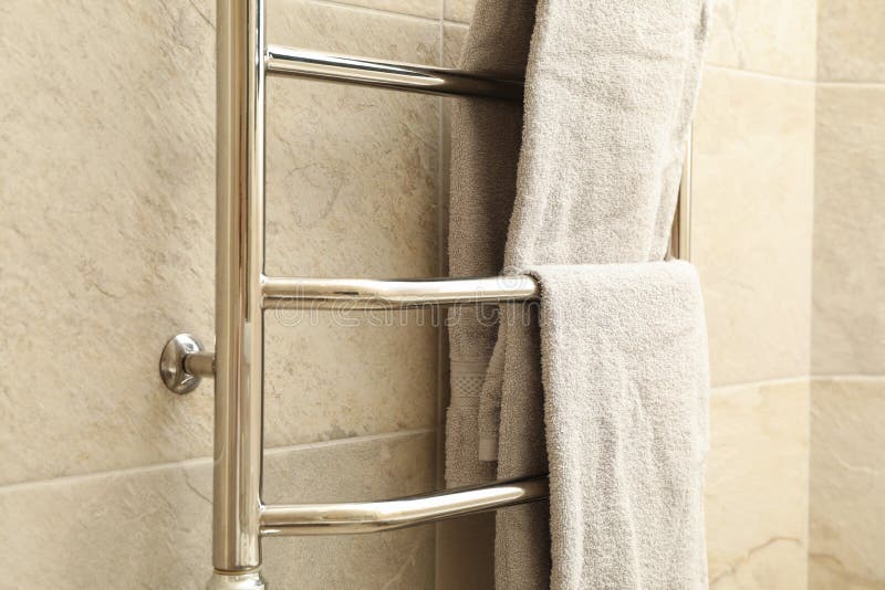Modern Heated Towel Rail on Tiled Bathroom Wall Stock Photo - Image of ...