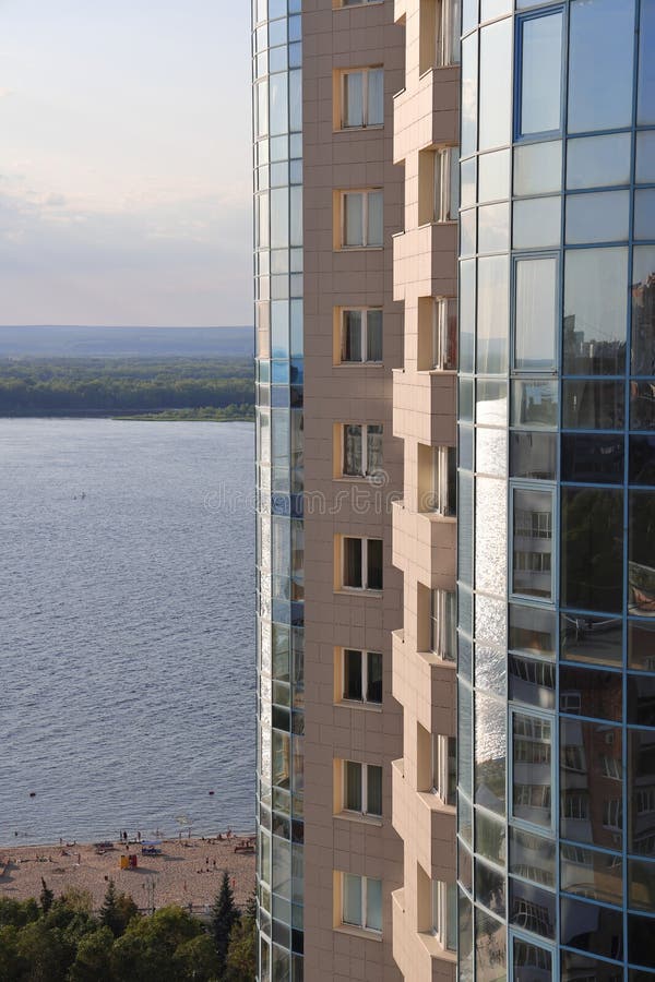 Modern High Building on the Background of the River, Sandy Beach on the ...