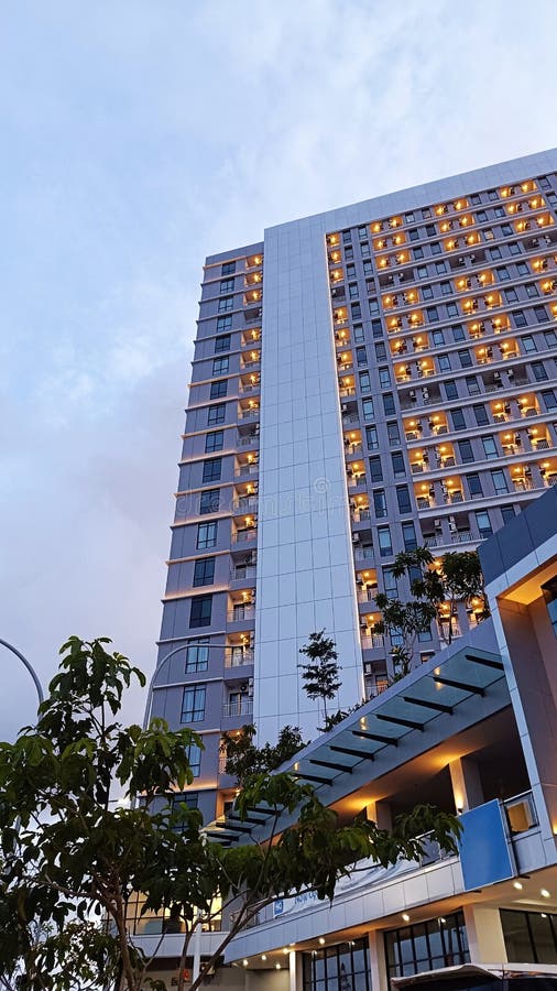 Modern High-rise Apartment Building with Well Light Balconies at Dusk ...