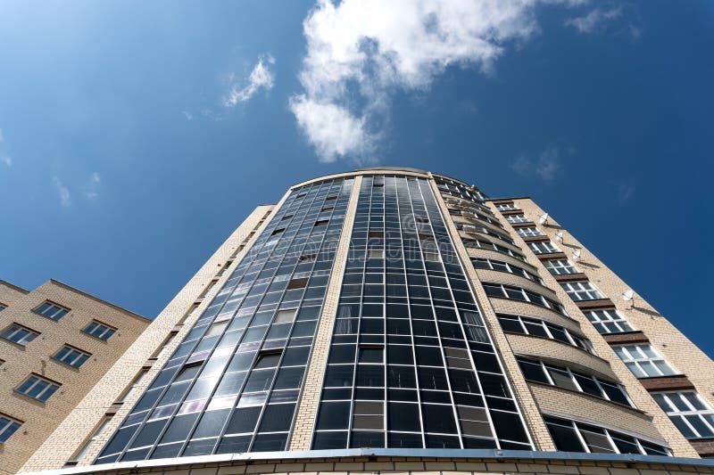A Modern High-rise Building with Panoramic Windows Rises Against the ...