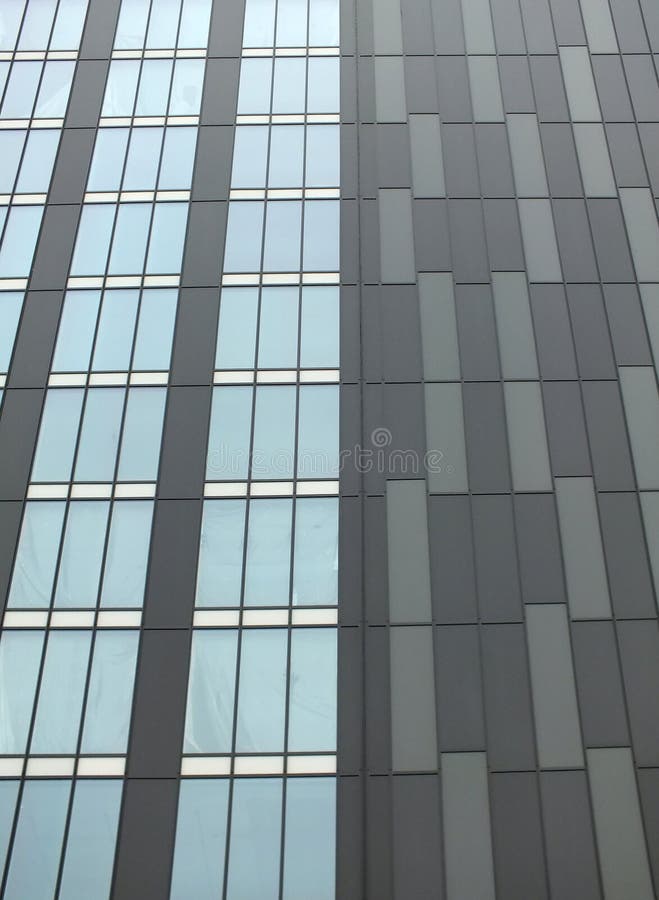 Modern Highrise Building with Grey Cladding and Vertical Windows Stock ...