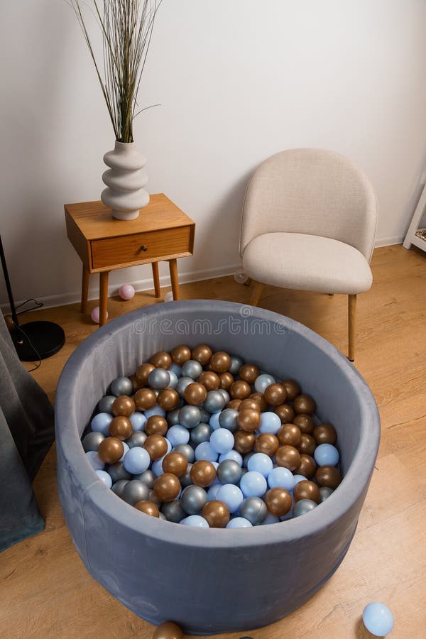 Modern Home Interior with Stylish Ball Pit Containing Blue, Bronze, and ...