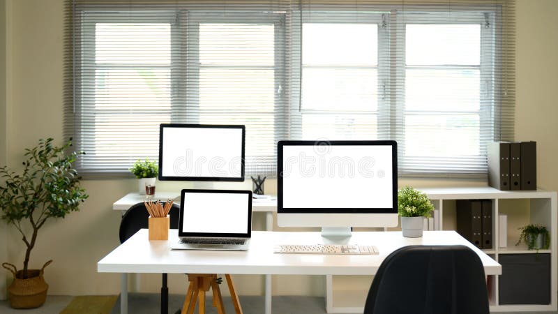 Modern Home Office with Desktop Computers and Laptop on White Desk with Blank Screens Stock ...