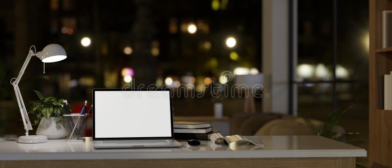 Modern Home Workspace at Night with Laptop, Table Lamp, Stationery and ...