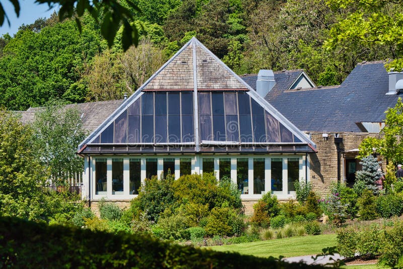 Modern House with Triangular Glass Facade in Lush Greenery Stock Photo ...