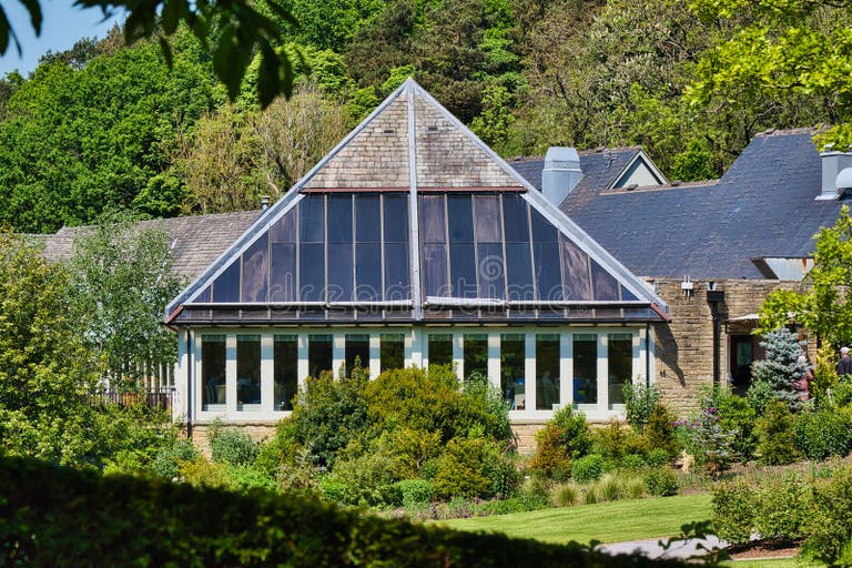 Modern House with Triangular Glass Facade in Lush Greenery Stock Photo ...