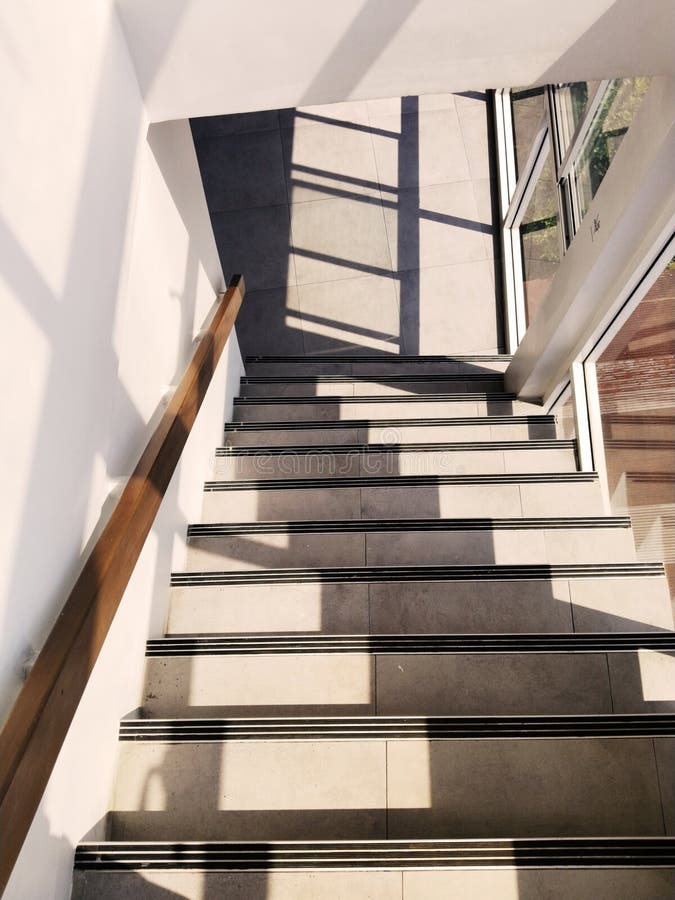 Modern Indoor Staircase with Sunlight and Shadows Stock Image - Image ...