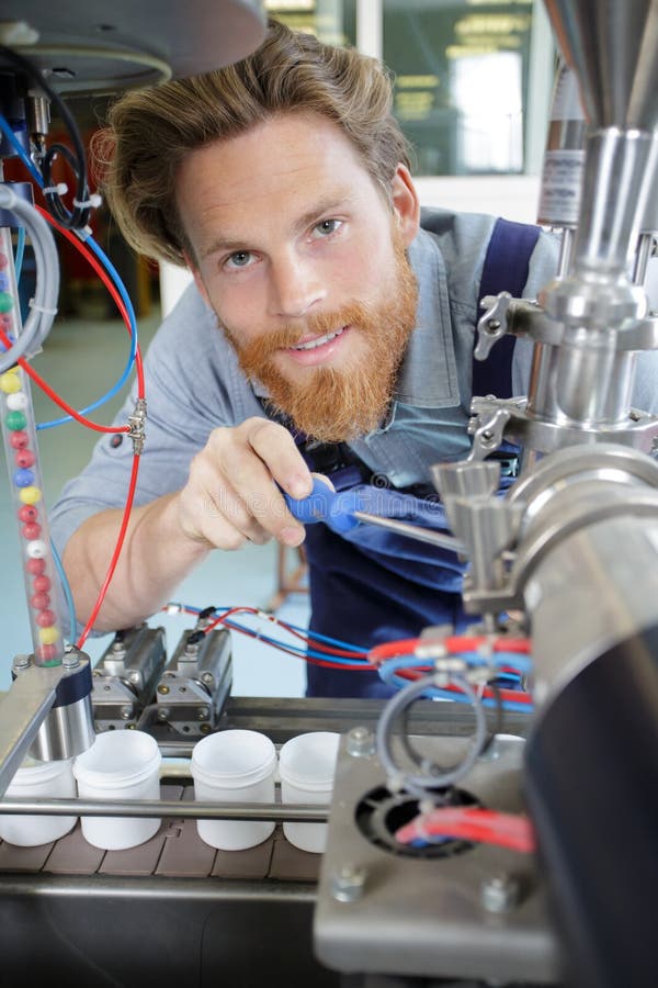 Modern Industrial Machine Operator Working on Machine Stock Photo ...